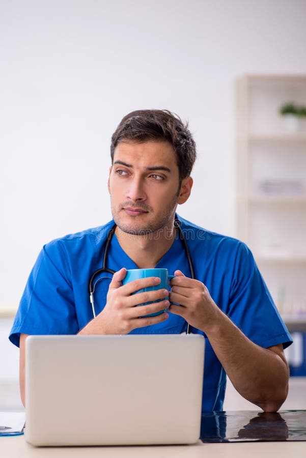 Young Male Doctor Drinking Coffee during Break Stock Image - Image of ...