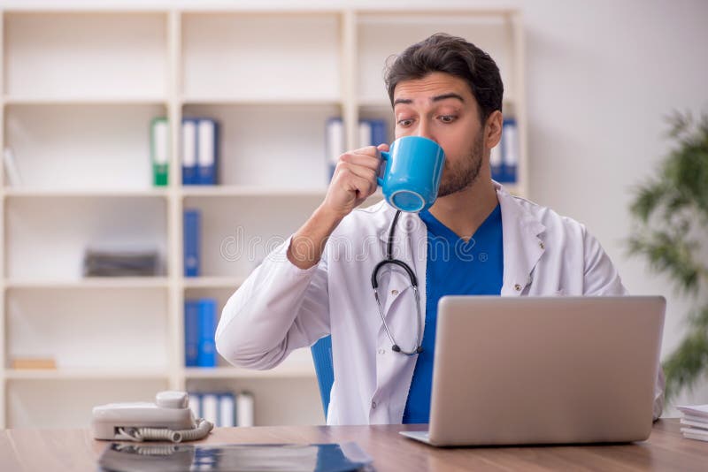 Young Male Doctor Drinking Tea during Break Stock Image - Image of ...