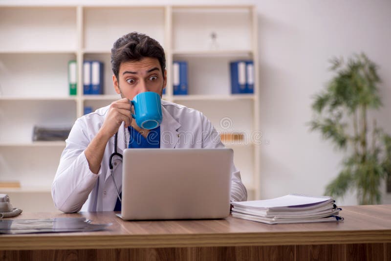 Young Male Doctor Drinking Tea during Break Stock Image - Image of ...
