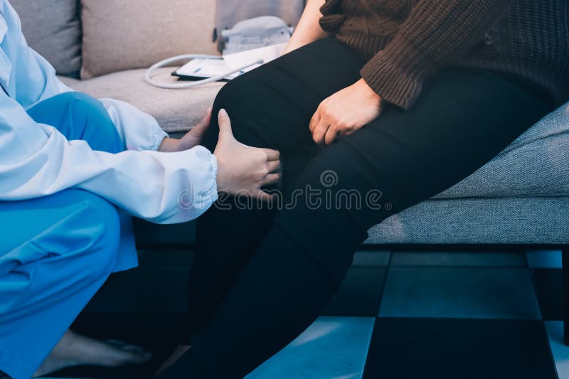 Young Doctor Examines Senior Patient& X27;s Leg Stock Image - Image of ...
