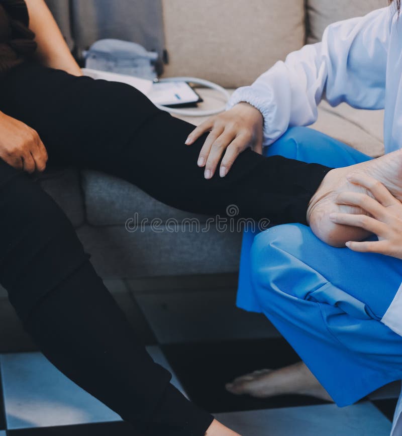 Young Doctor Examines Senior Patient& X27;s Leg Stock Photo - Image of ...