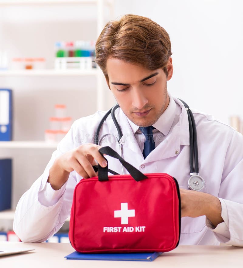 Young Doctor with First Aid Kit in Hospital Stock Photo - Image of ...