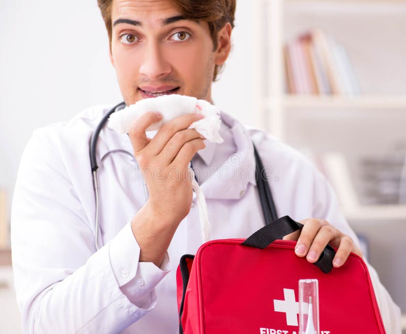 Young Doctor with First Aid Kit in Hospital Stock Photo - Image of ...