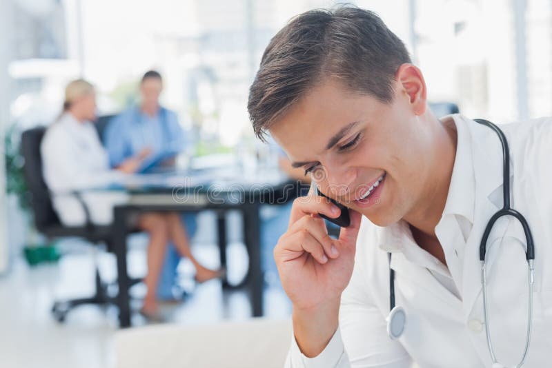 Young Doctor Having a Phone Call Stock Photo - Image of service, office ...