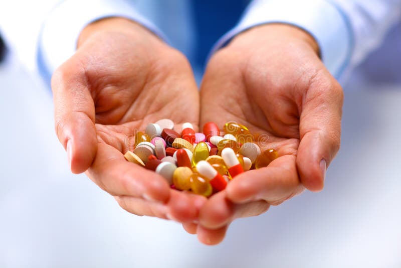 Young Doctor Holding Pills in His Outstretched Hand Packaging Stock ...