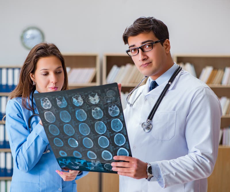 Young Doctor Looking at Computer Tomography X-ray Image Stock Image ...