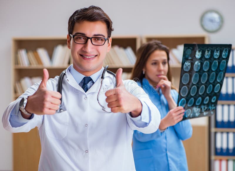 Young Doctor Looking at Computer Tomography X-ray Image Stock Photo ...