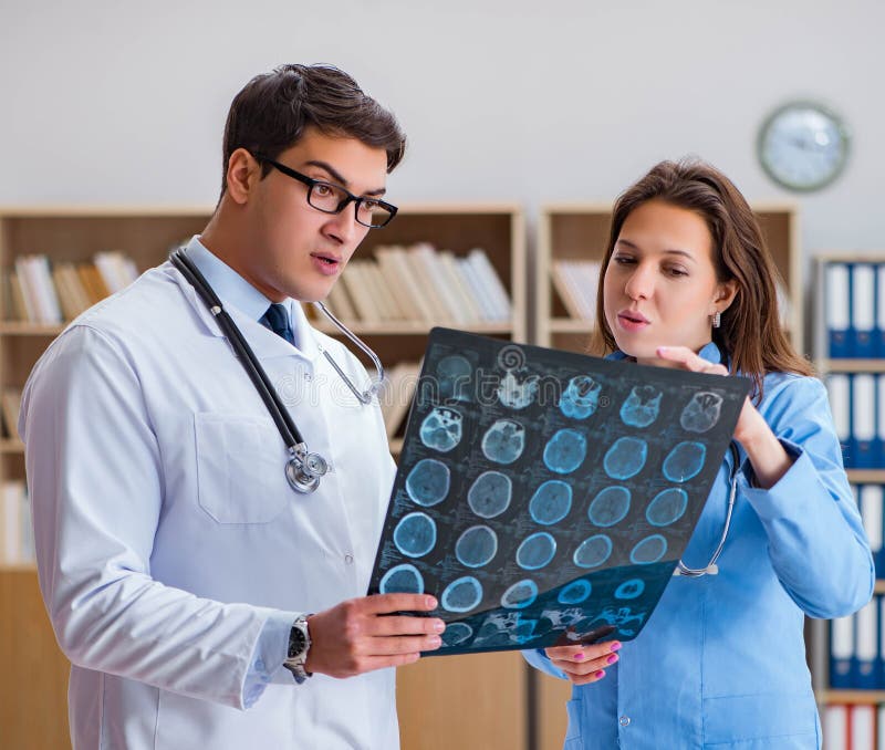 Young Doctor Looking at Computer Tomography X-ray Image Stock Image ...