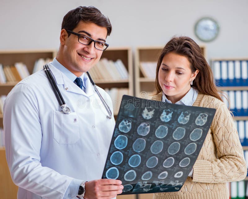 Young Doctor Looking at Computer Tomography X-ray Image Stock Photo ...