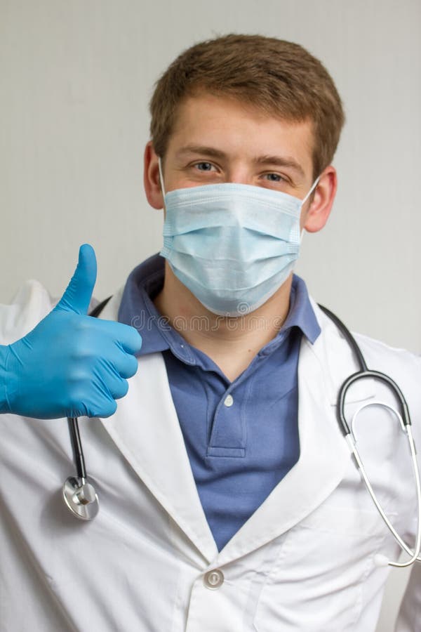 Young Doctor Making an Thumbs Up Sign Stock Image - Image of blue ...