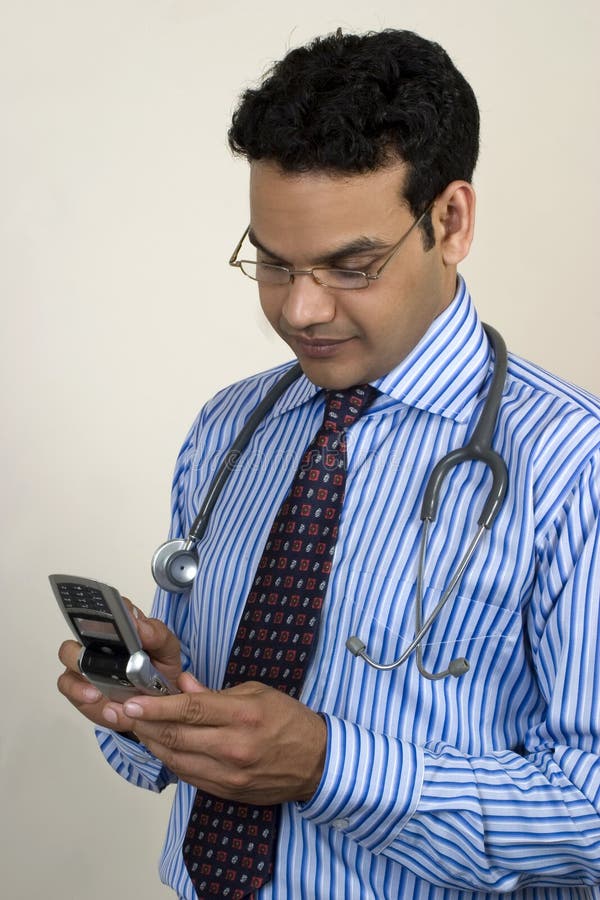 Young doctor with mobile stock image. Image of asian - 14688615