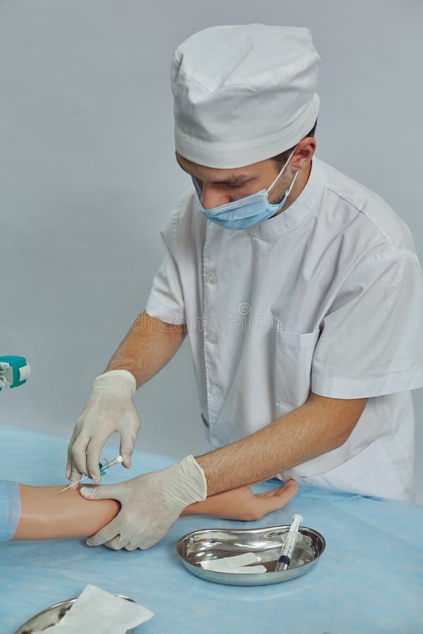 Young Doctor Performs a Peripheral Catheter Installation and Blood ...