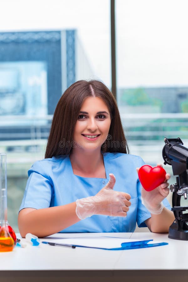 The Young Doctor with Red Heart in Lab Stock Image - Image of ...
