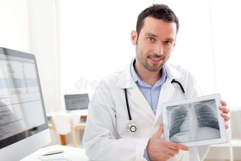 Young Doctor Showing Radiography on a Tablet Stock Photo - Image of ...