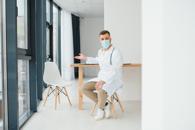 Young Doctor Sitting in His Office Behind a Desk Stock Image - Image of ...