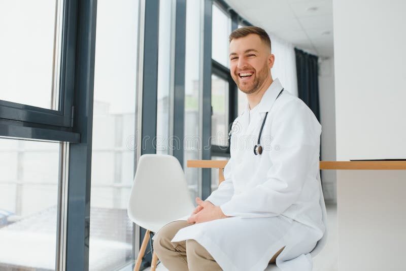 Young Doctor Sitting in His Office Behind a Desk Stock Image - Image of ...