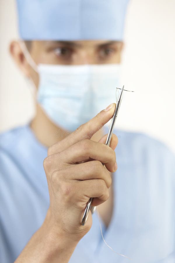 Surgical Needle in the Hands of the Surgeon Stock Image - Image of ...