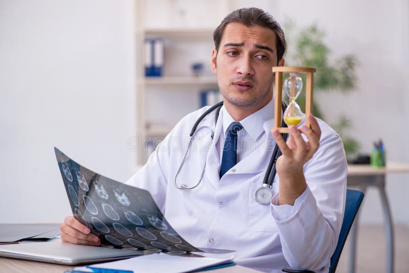 Young Male Doctor in Time Management Concept Stock Image - Image of ...