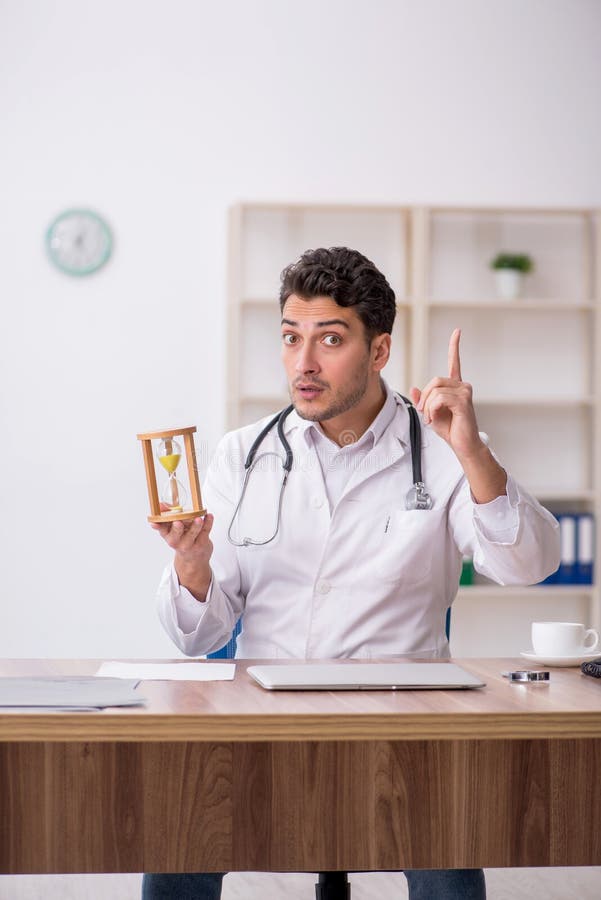 Young Male Doctor in Time Management Concept Stock Image - Image of ...