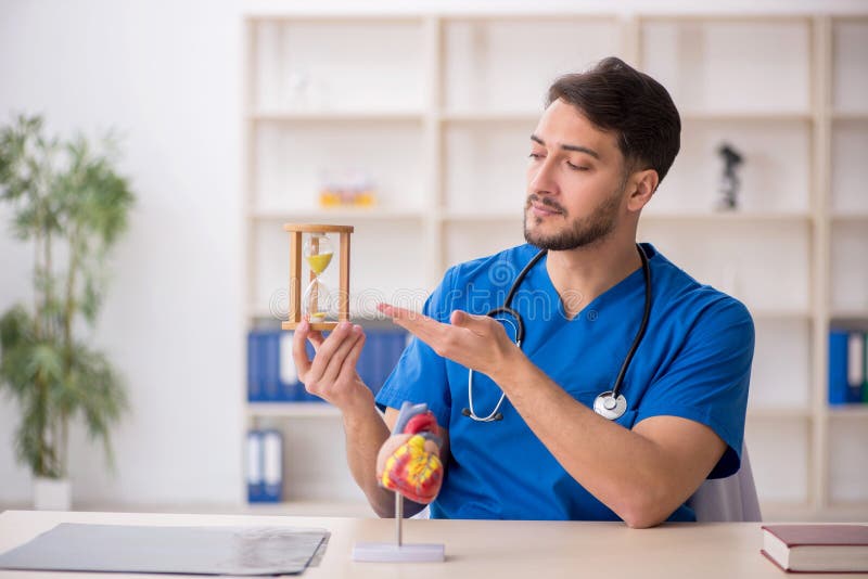 Young Male Doctor in Time Management Concept Stock Image - Image of ...