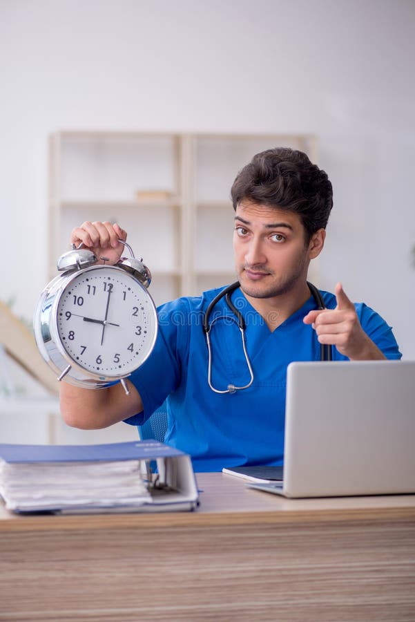 Young Male Doctor in Time Management Concept Stock Image - Image of ...