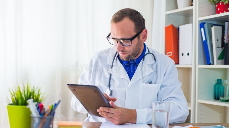 Doctor on his Cell Phone stock image. Image of technology - 10018875