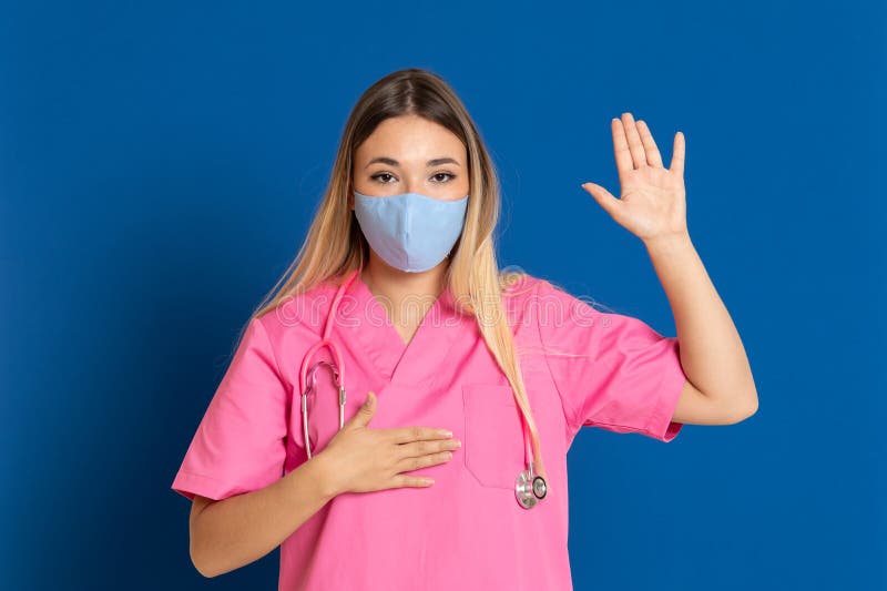 Young Doctor Wearing a Mask Face and a Pink Uniform Stock Image - Image ...