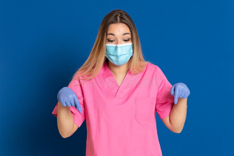 Young Doctor Wearing a Mask Face and a Pink Uniform Stock Photo - Image ...