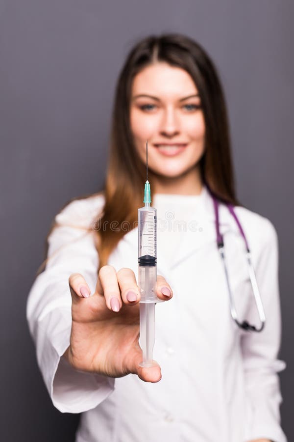 Young Doctor Woman with Syringe on Grey Background Stock Photo - Image ...