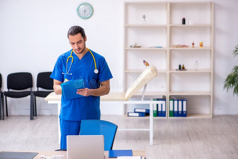 Young Male Doctor Working in the Clinic Stock Image - Image of notebook ...