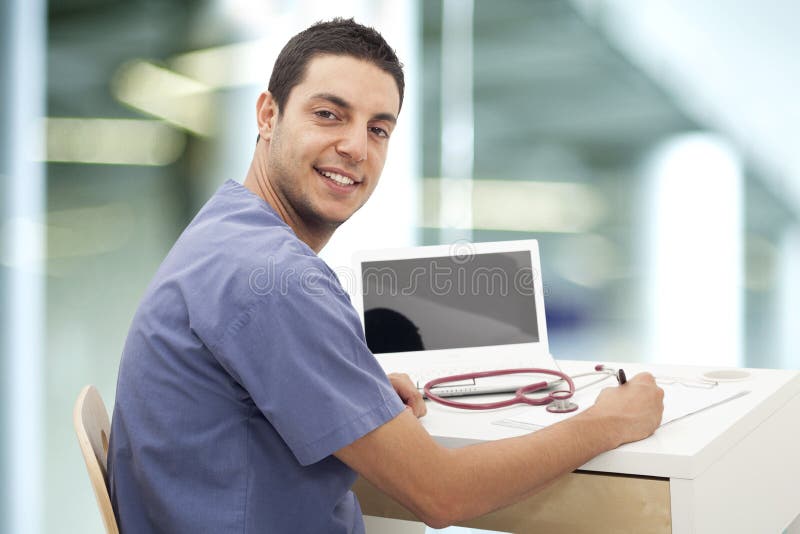 Young Doctor Working in Hospital Stock Photo - Image of table, blue ...