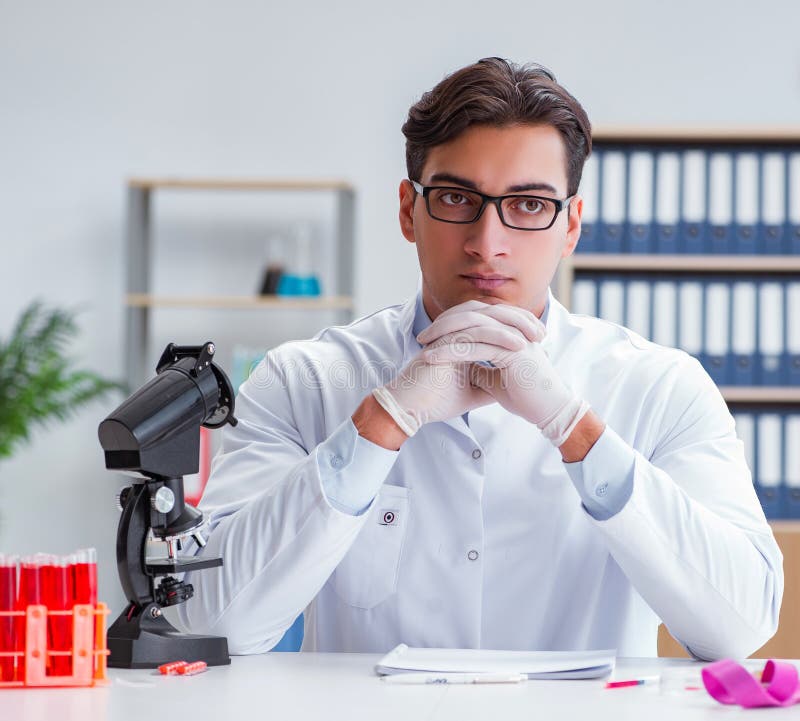 Young Doctor Working in the Lab with Microscope Stock Photo - Image of ...