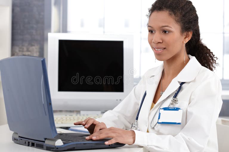 Young Doctor Working on Laptop Computer Smiling Stock Photo - Image of ...