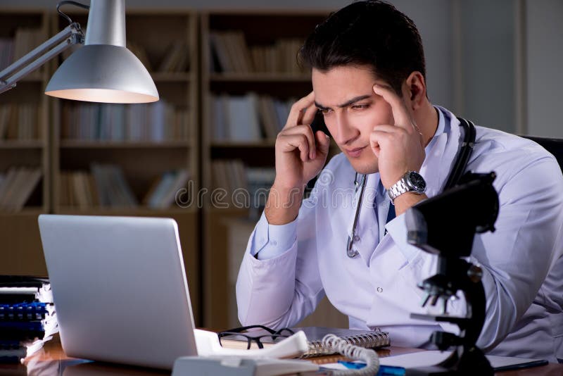 The Young Doctor Working Late in the Office Stock Image - Image of ...