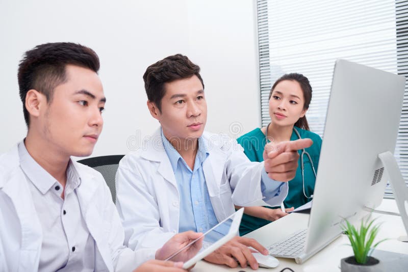Young Doctors Using Computer in Hospital Office Stock Photo - Image of ...