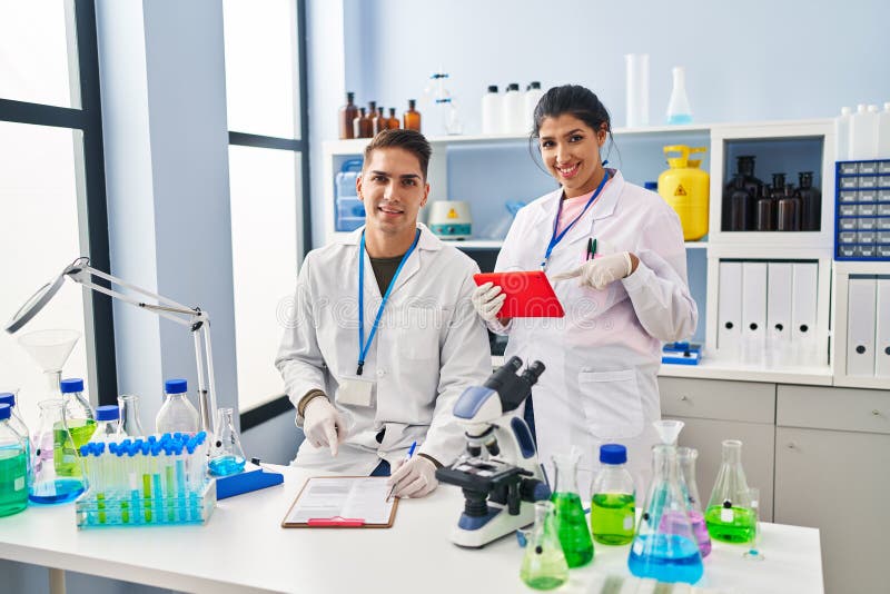 Young Doctors Working at Scientist Laboratory Smiling Happy Pointing ...