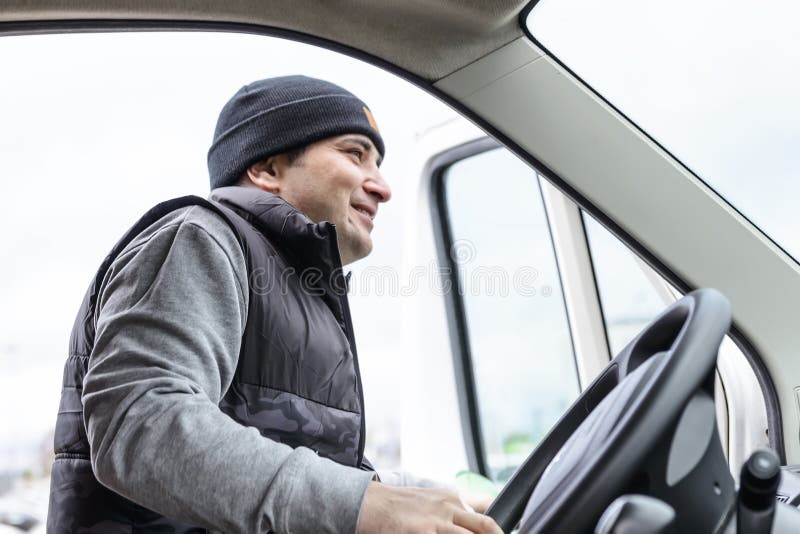 Young Driver of a Heavy Truck with a Smile Sits Behind the Wheel. Stock ...
