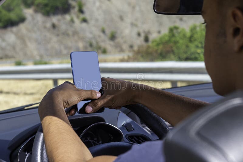 Young Driver, Using Smartphone, on the Road in the Car Stock Photo ...