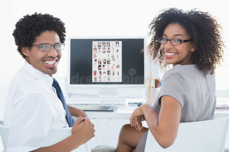 Young Editorial Team Working Together Smiling at Camera Stock Image ...