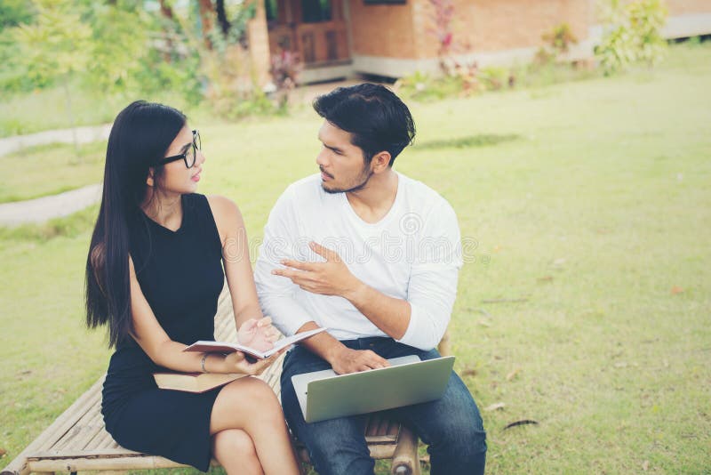 Young Education Couple Sitting on the Bench Talk about Study in Stock Photo - Image of person ...