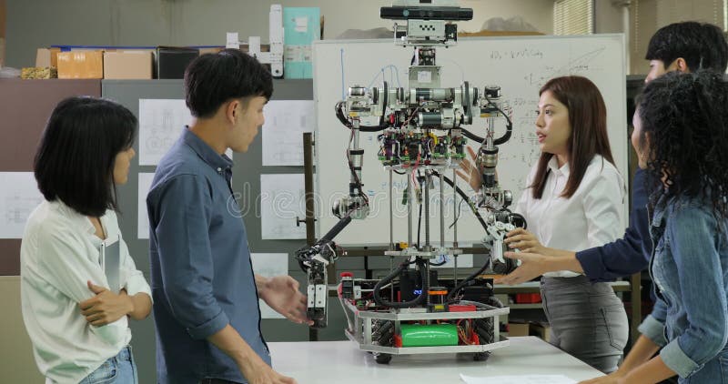 Young Electronics Engineer Team Collaborating on Construction of Robot ...
