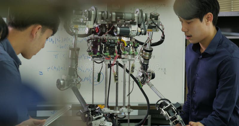 Young Electronics Engineer Team Collaborating on Construction of Robot ...