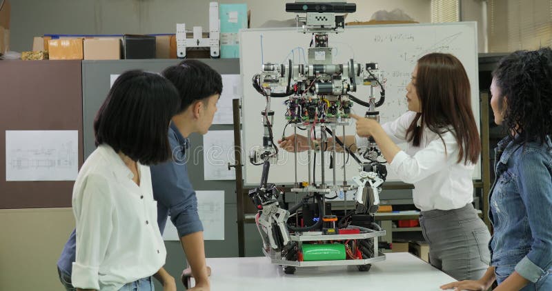 Young Electronics Engineer Team Collaborating on Construction of Robot ...