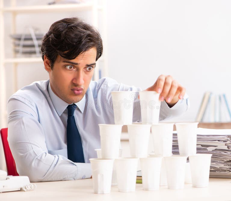 Young Employee Building Pyramid from Plastic Cups Stock Photo - Image ...