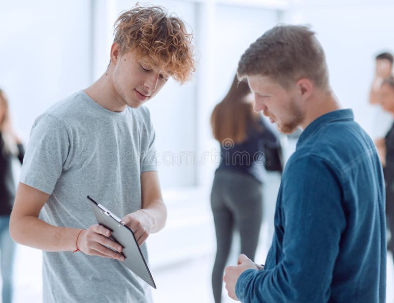 Young Employee with a Digital Tablet Talking To His Colleague Stock ...