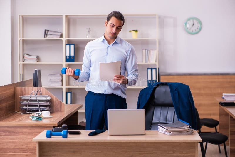 Young Male Employee Doing Physical Exercises at Workplace Stock Image ...