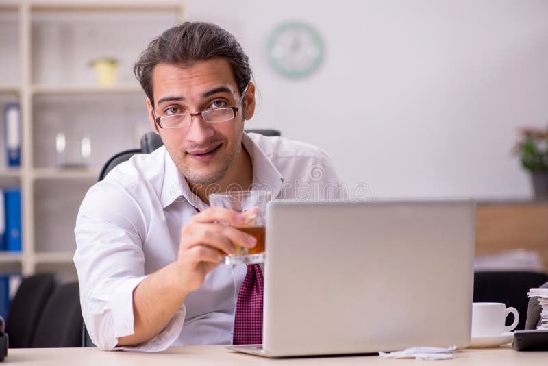 Young Male Employee Drinking Alcohol in the Office Stock Photo - Image ...