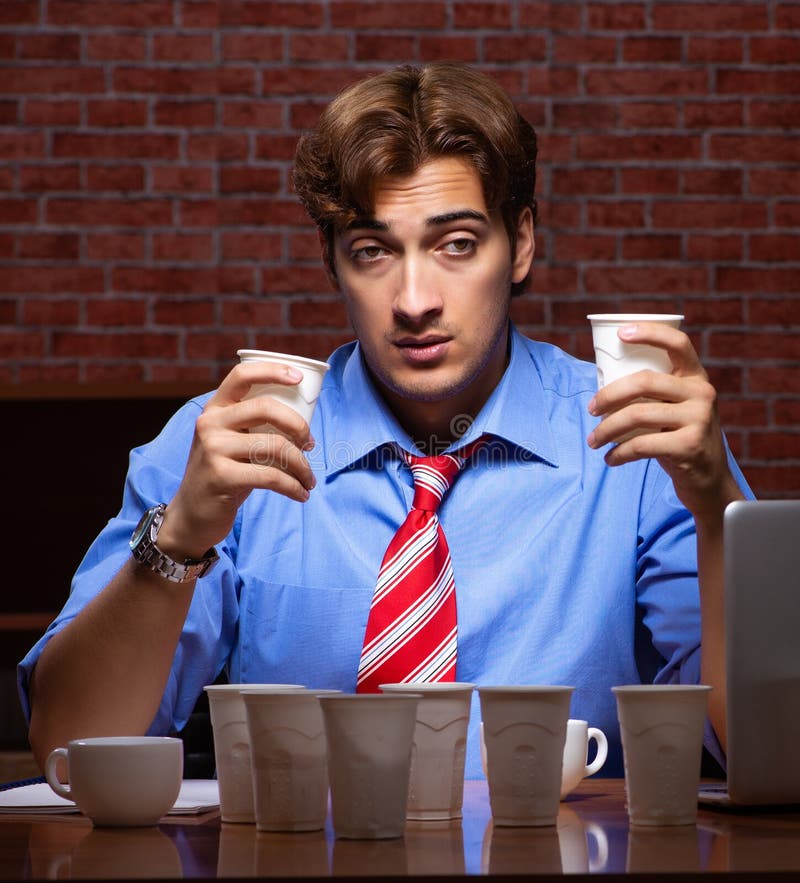The Young Employee Drinking Coffee Working at Night Shift Stock Image ...