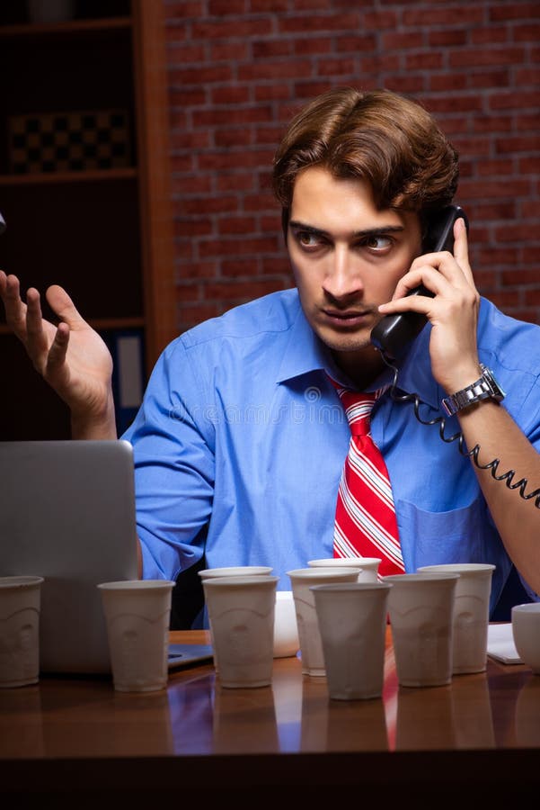 The Young Employee Drinking Coffee Working at Night Shift Stock Image ...