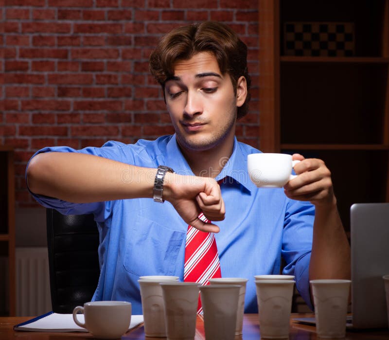 Young Employee Drinking Coffee Working at Night Shift Stock Photo ...